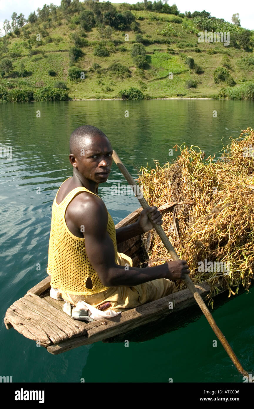 A traditional boatman carries soya in his wooden boat on Lake Kivu in ...