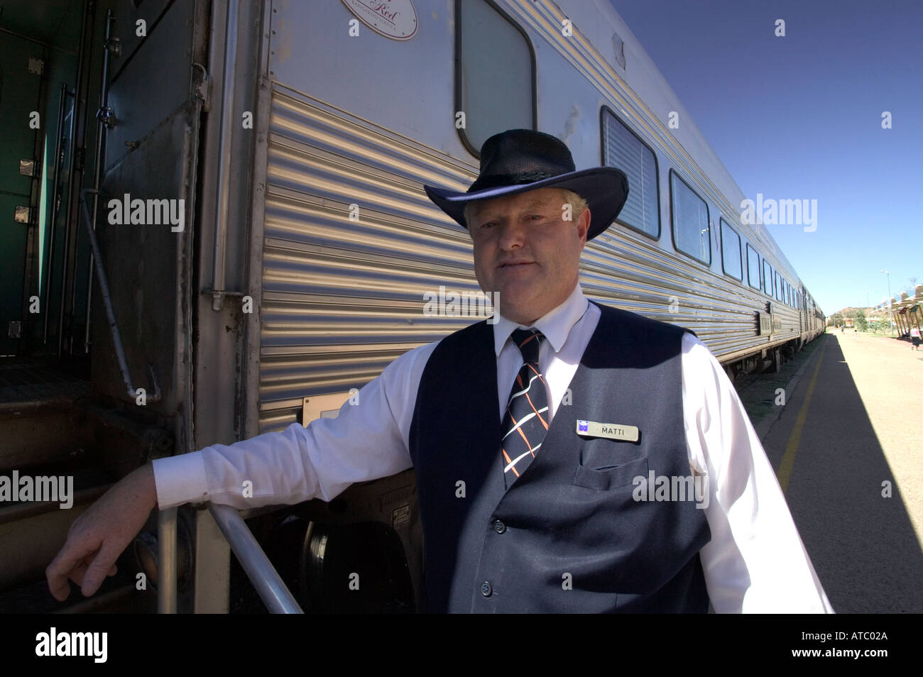 Steward welcoming passengers on board Ghan train at Katherine station ...