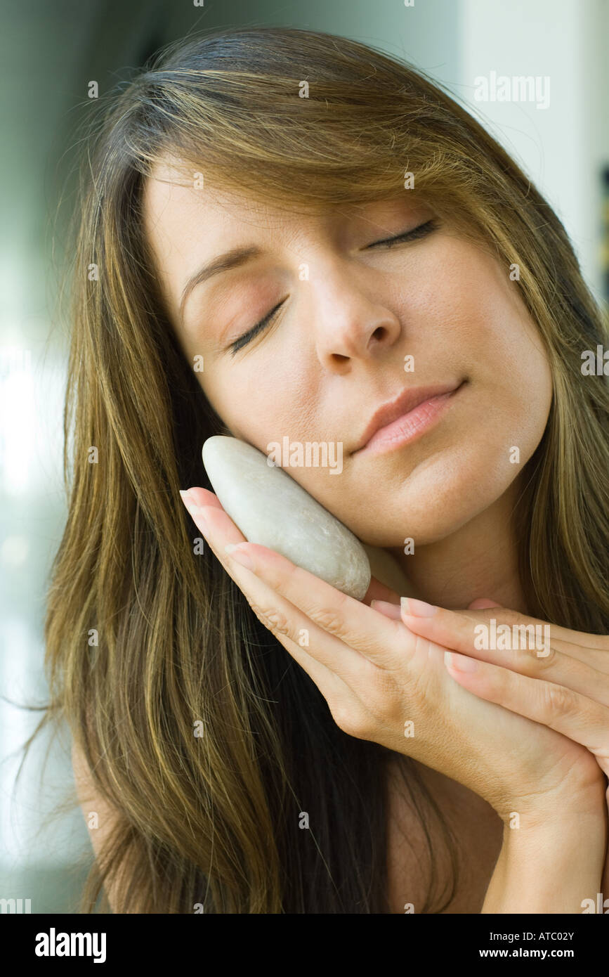 Woman holding hand against her cheek hi-res stock photography and ...