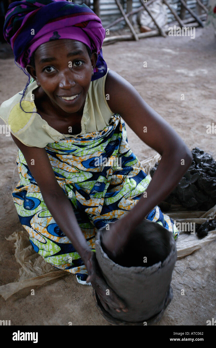 A young woman from the Batwa community of Kigali making a traditional ...
