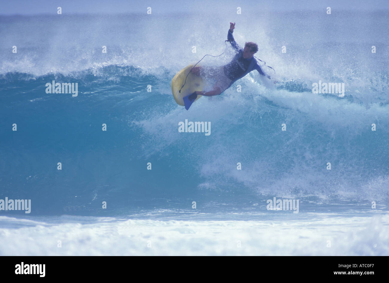 Australia Qld bodyboarder in dropknee stance Stock Photo - Alamy
