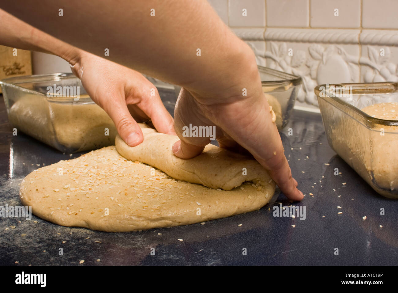 Makeing homemade bread showing hands folding dough Stock Photo - Alamy