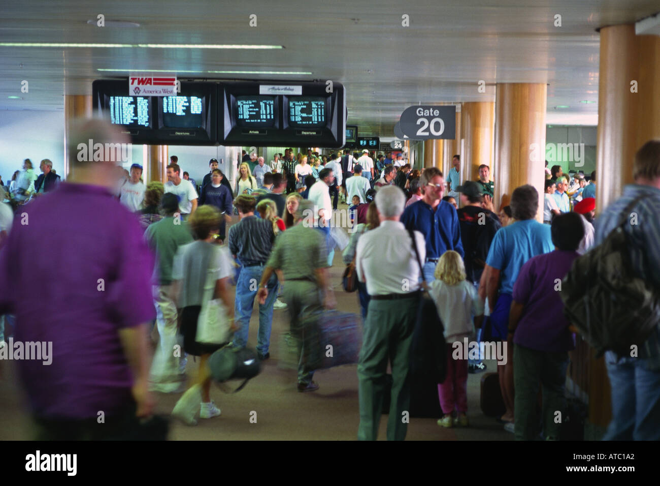 Crowded airport concourse corridor filled with people at San Francisco ...