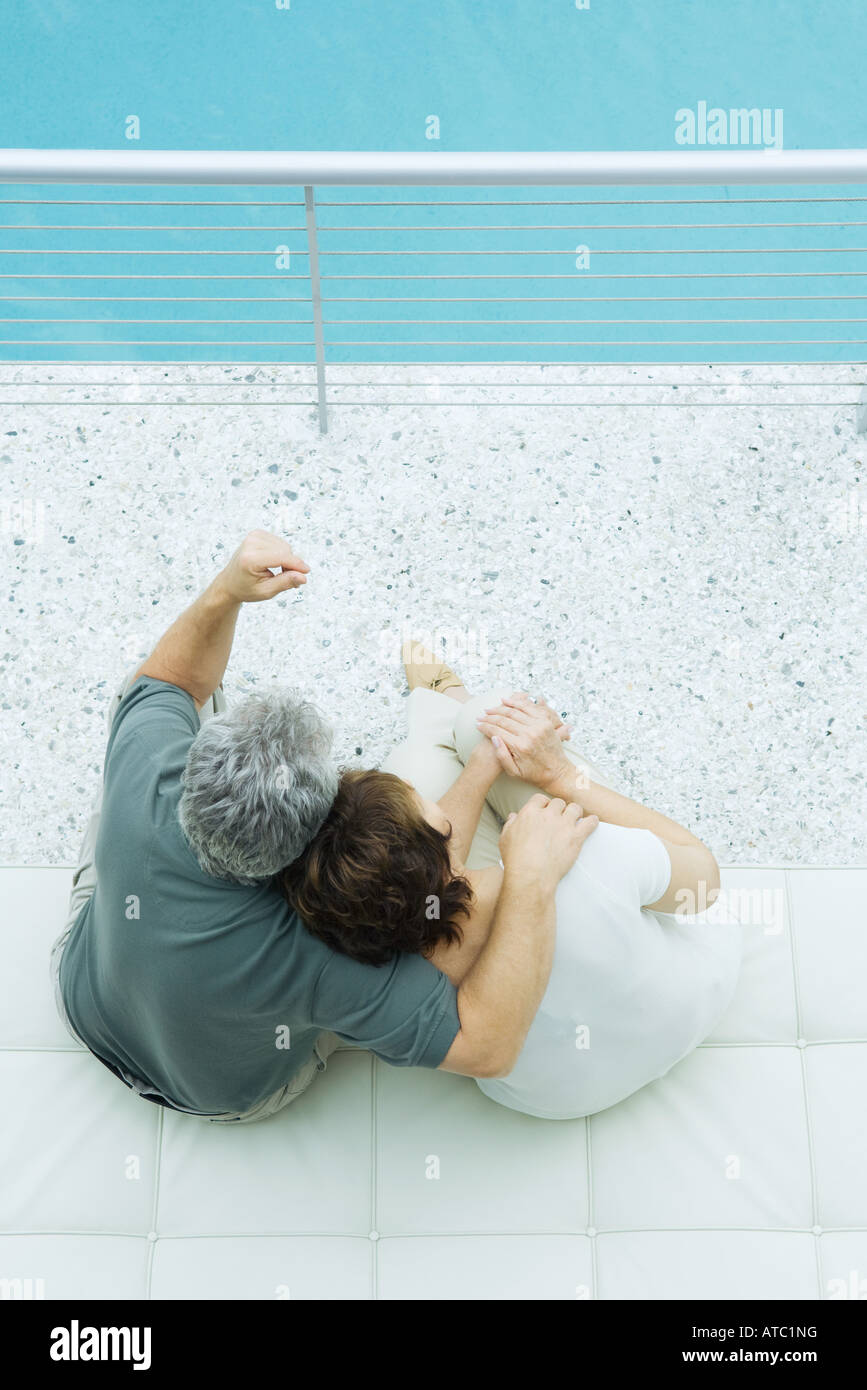 Two couples sitting by swimming pool hi-res stock photography and ...