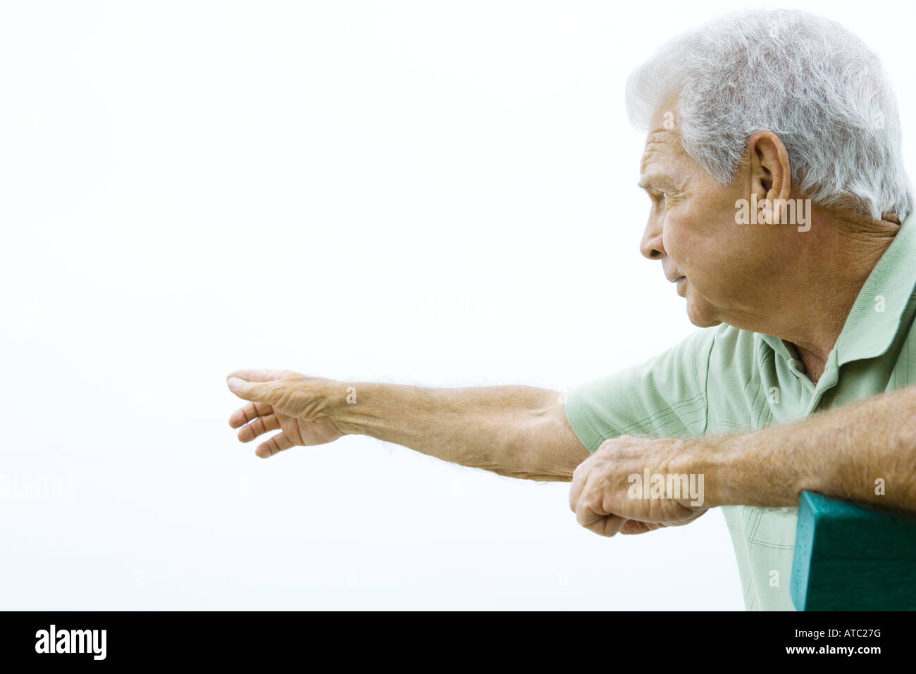 Senior man pointing, looking away, side view Stock Photo - Alamy