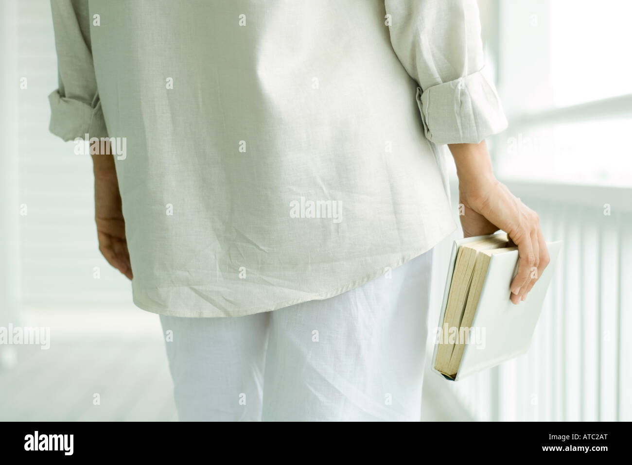 Person carrying book, cropped rear view Stock Photo - Alamy