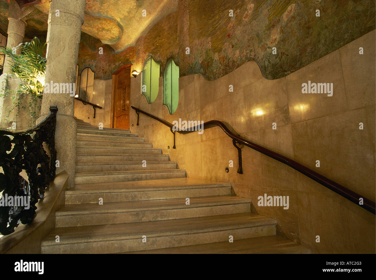 Wrougt iron work subtle lighting and plants decorate the broad ...