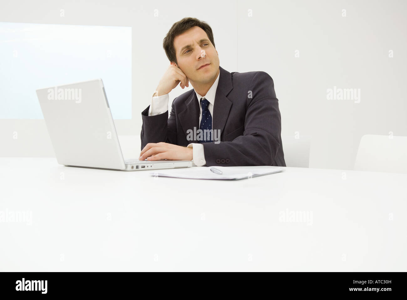 Professional individual uses laptop in hi-res stock photography and ...