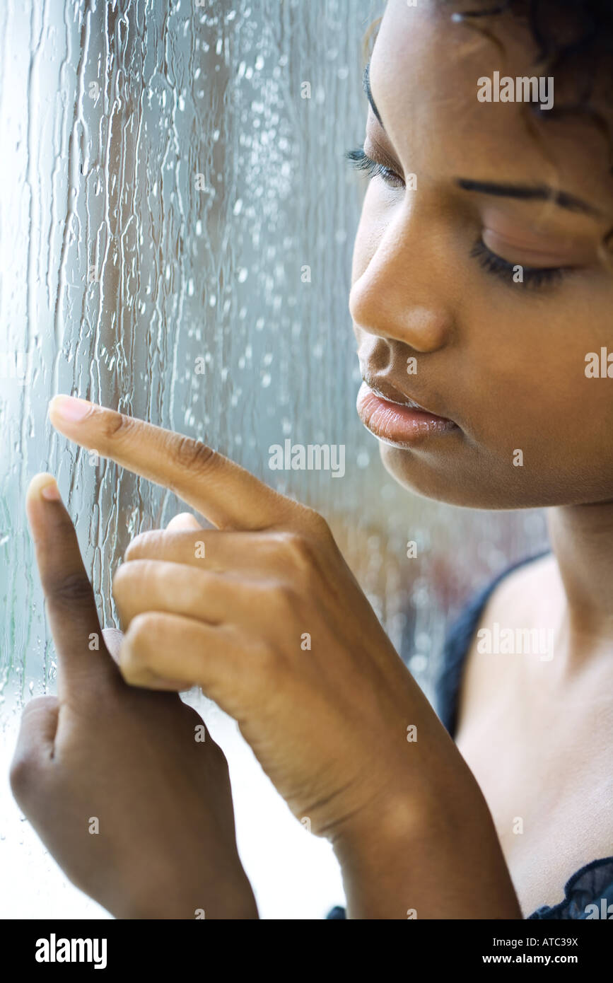Mother and child touching rain streaked window, cropped view Stock ...