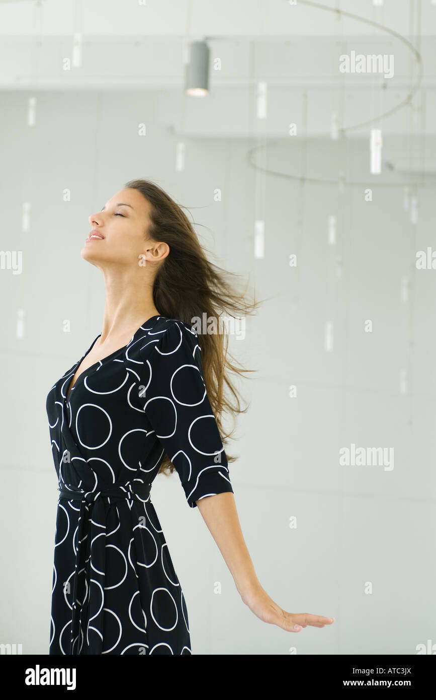 Teenage girl with hair blowing in breeze, head back, eyes closed Stock ...