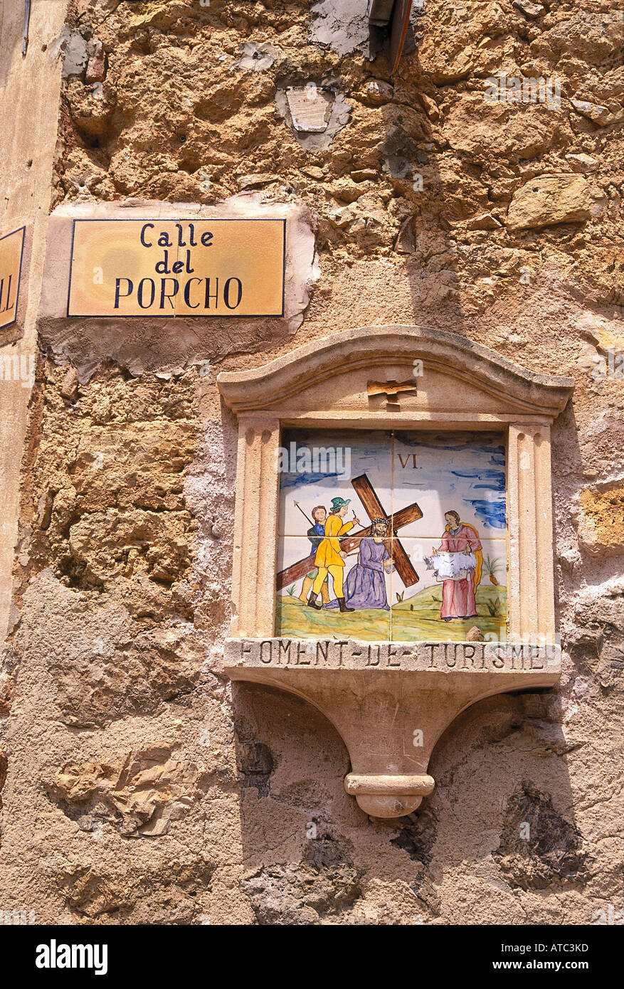A street sign above a small icon depicting figures carrying the ...