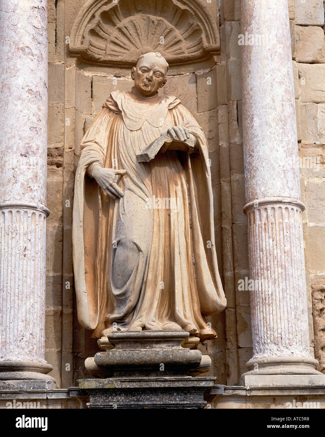 Detail of a robed statue set in a decorative niche between pillars on ...