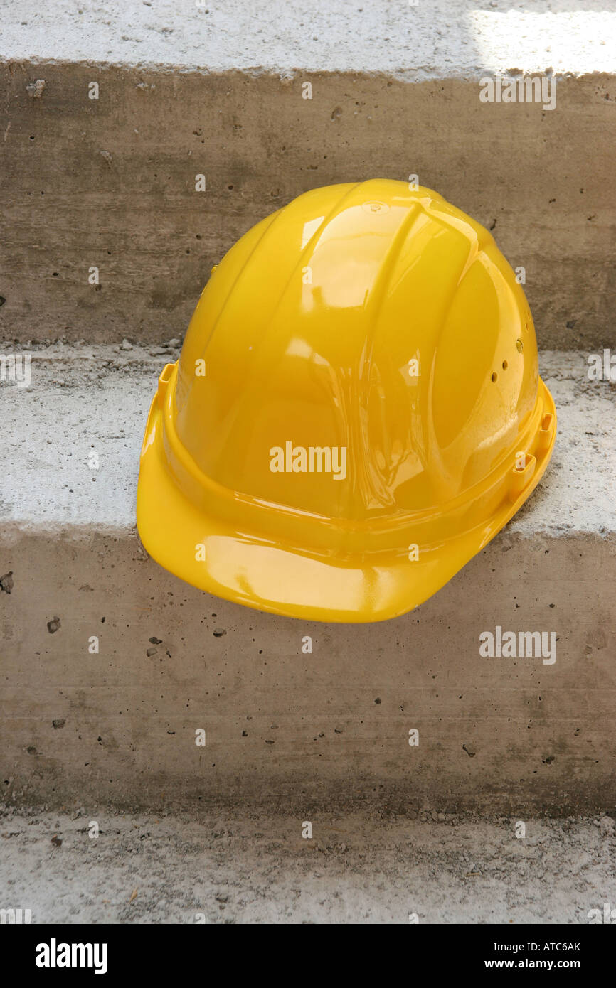 yellow work helmet on a building site Stock Photo - Alamy