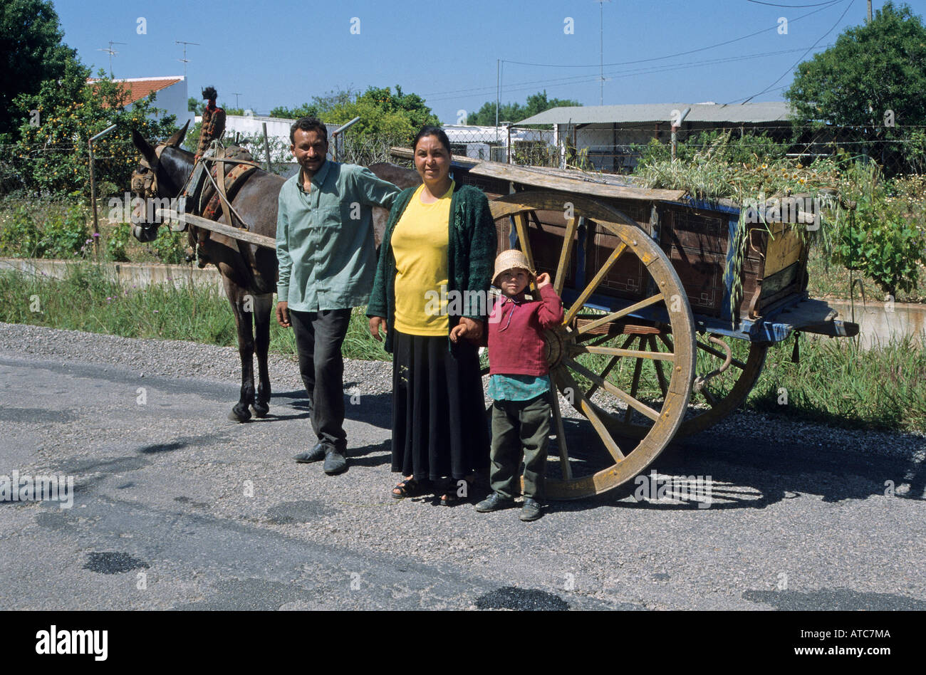 A farming family stop and pose beside their donkey driven cart at the ...