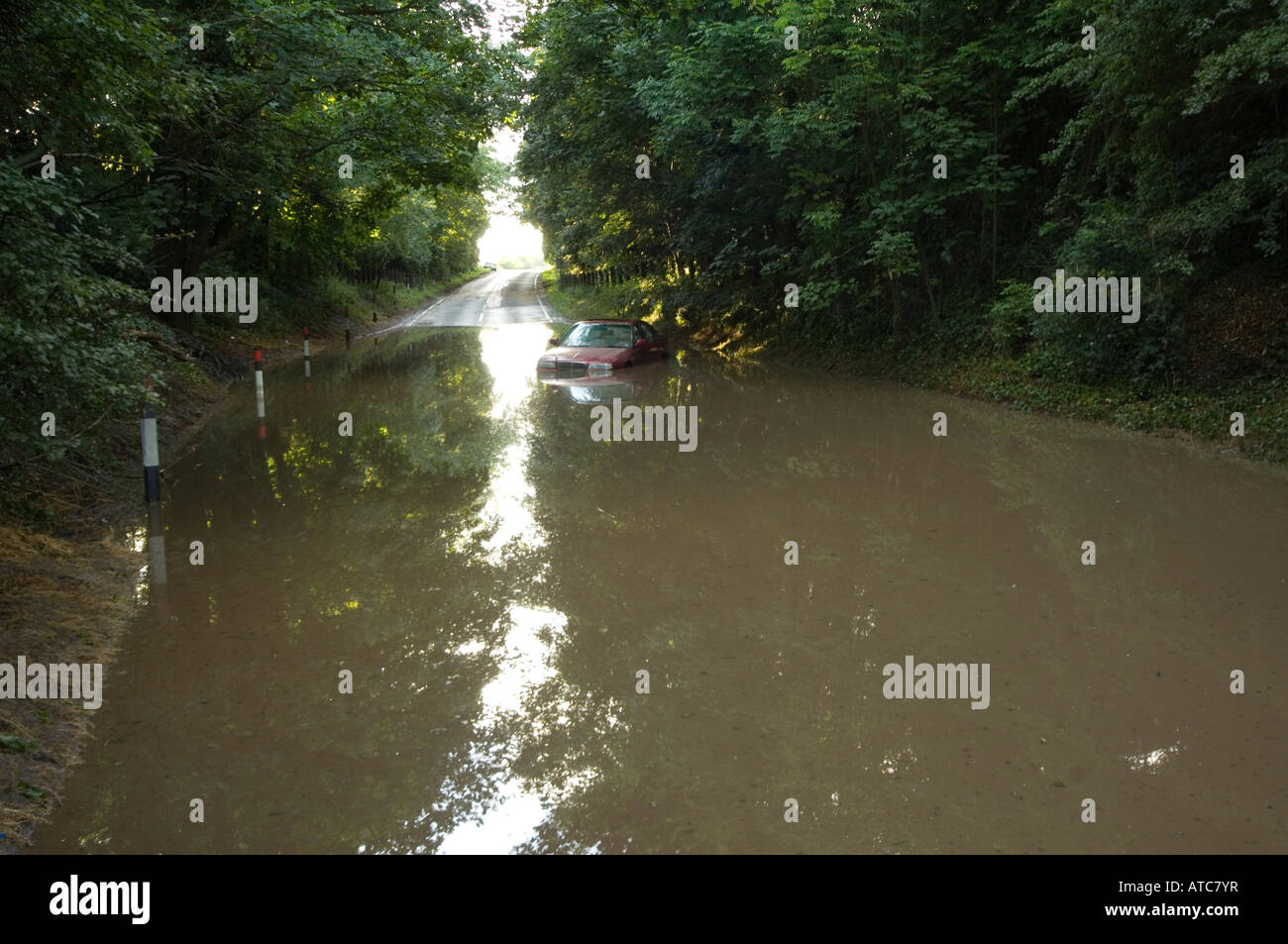 Summer Flooding, Local Road with half submerged car Stock Photo - Alamy