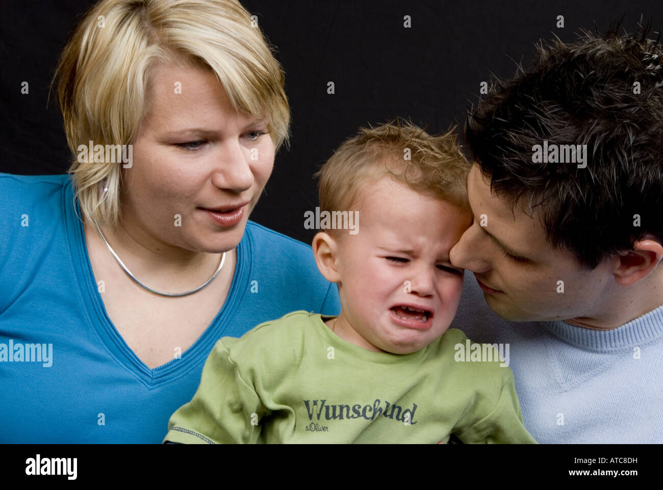 parents with their crying son Stock Photo - Alamy