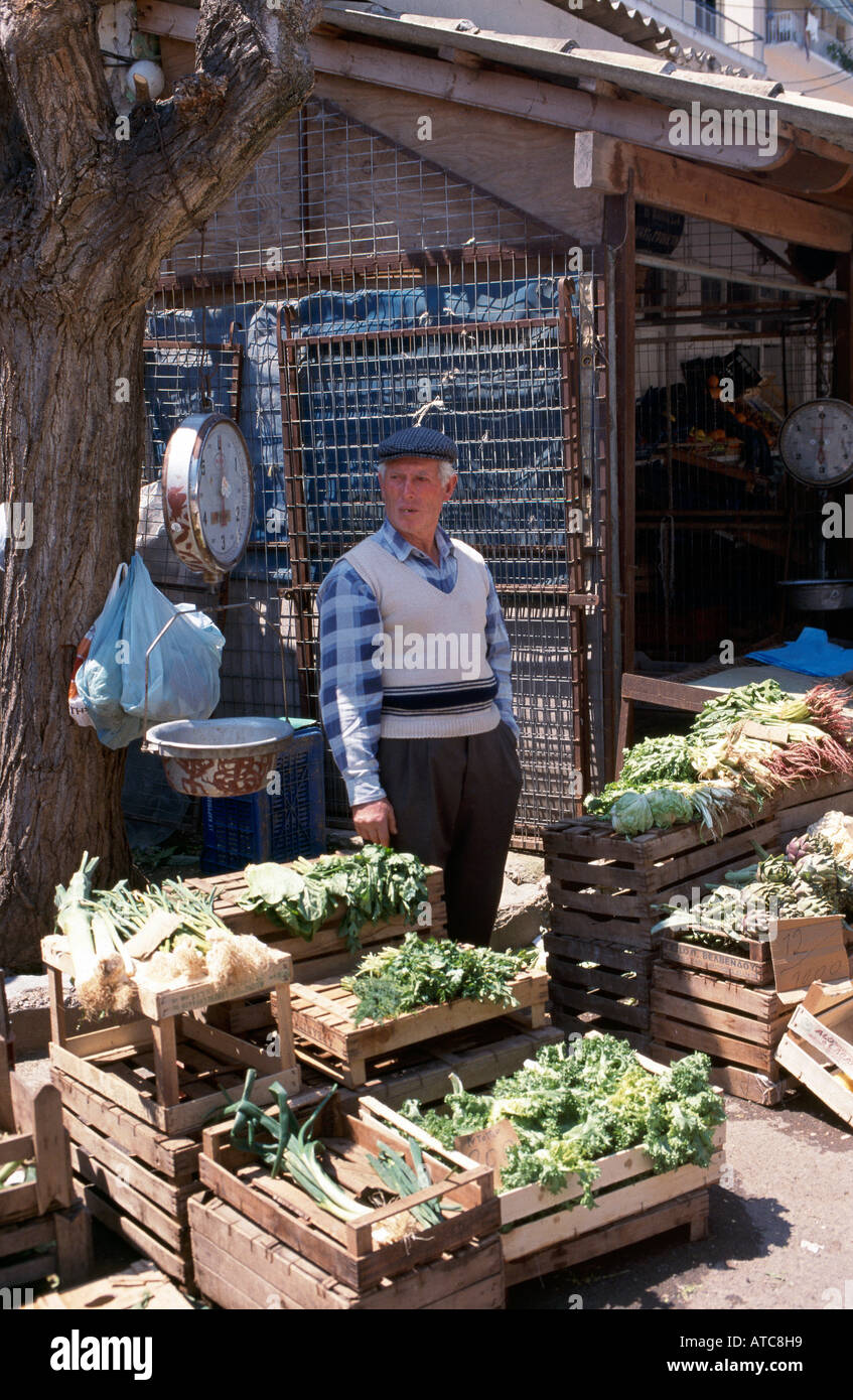 A stallholder selling fresh vegetables on a market north of Corfu s San ...