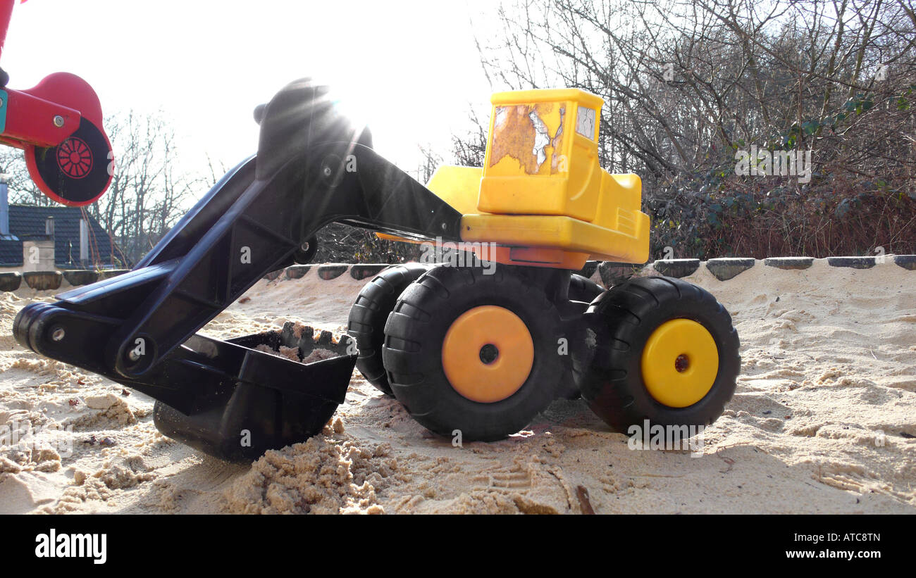 toy - digger in sandbox Stock Photo - Alamy