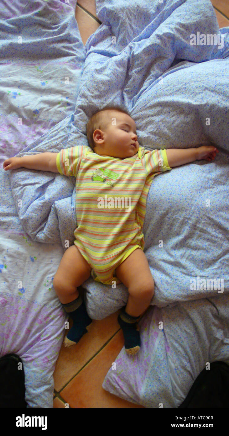 baby sleeeping with outstretched arms Stock Photo - Alamy