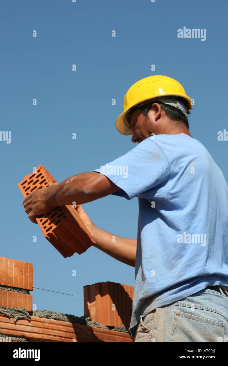 Workers building up a brick wall Stock Photo - Alamy