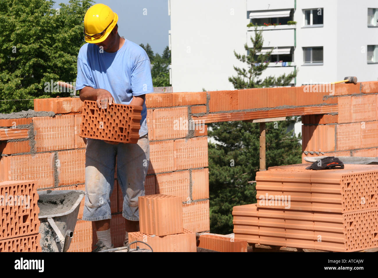 Workers building up a brick wall Stock Photo - Alamy
