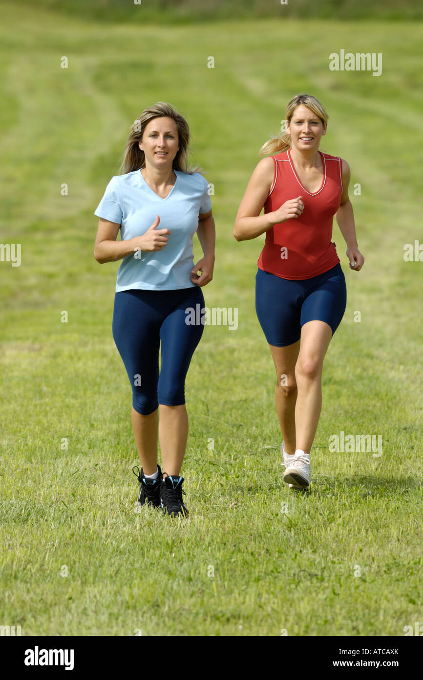 Two young women jogging Stock Photo - Alamy