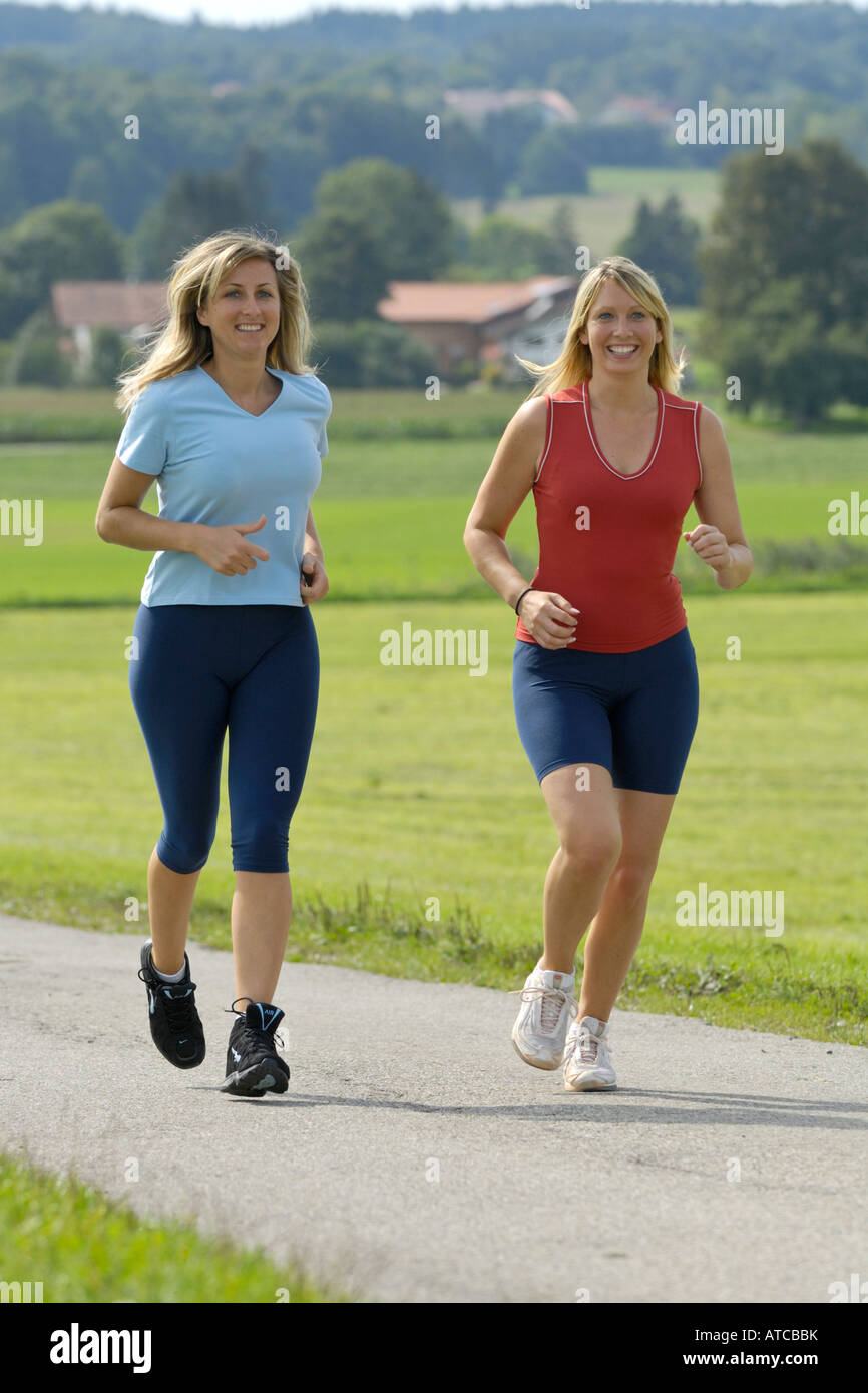Two young women jogging Stock Photo - Alamy