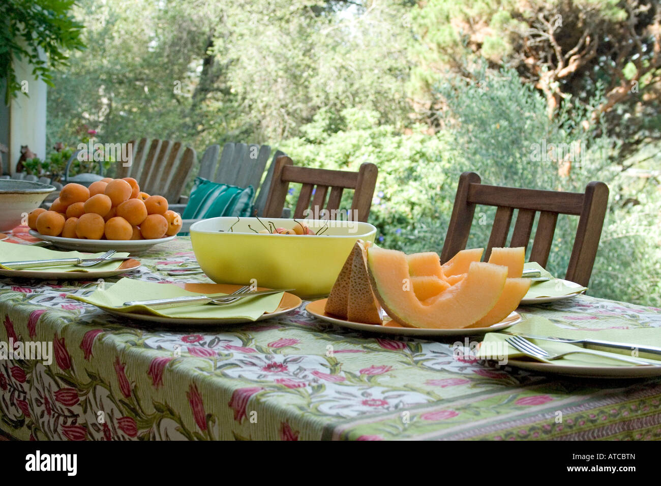 outdoor dining on patio with fresh summer fruit Stock Photo - Alamy