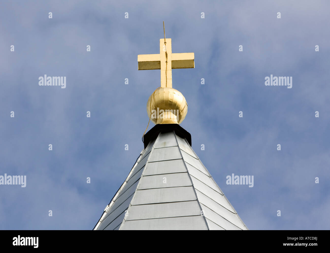 Gold-plated Lutheran church cross against blue sky , Finland Stock ...