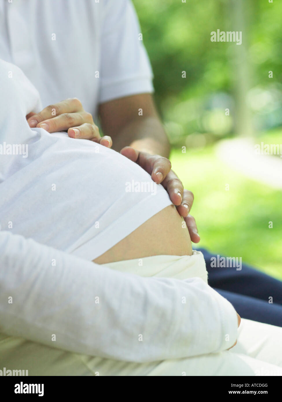 midsection of pregnant woman and husband Stock Photo - Alamy