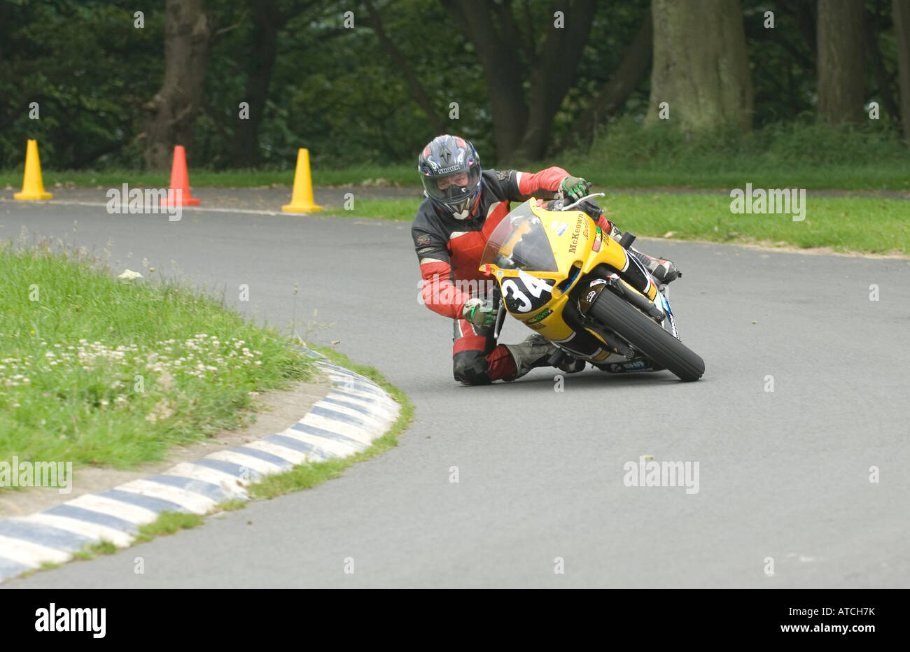 Superbike Rider with his Knee on the ground for stability while ...