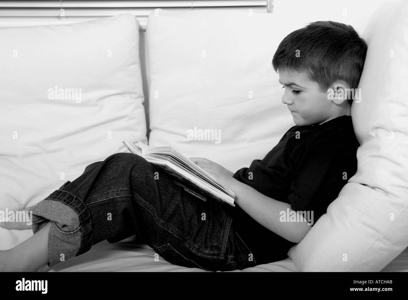 Black and white boy reading on sofa hi-res stock photography and images ...