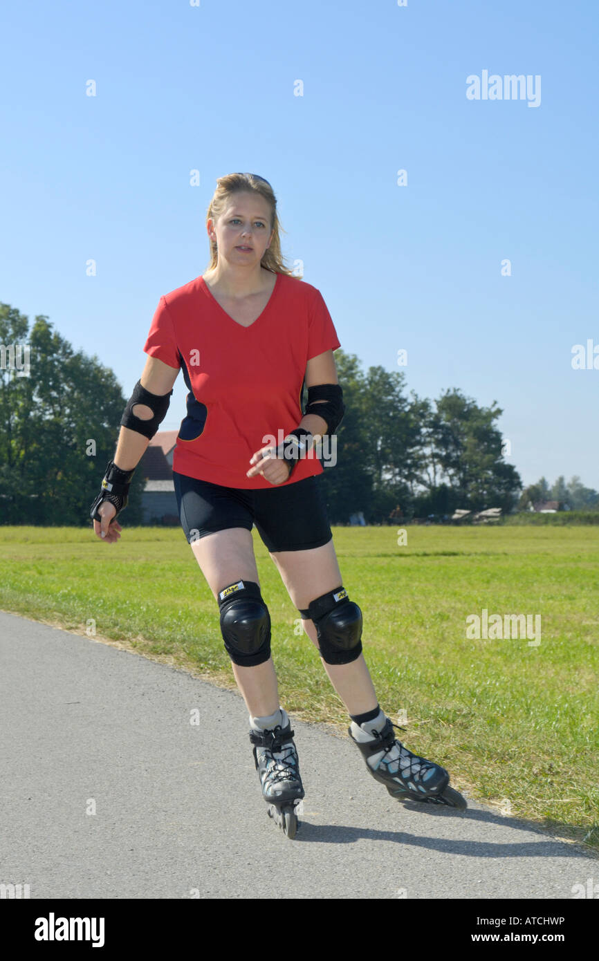 Young Woman roller blading Stock Photo - Alamy
