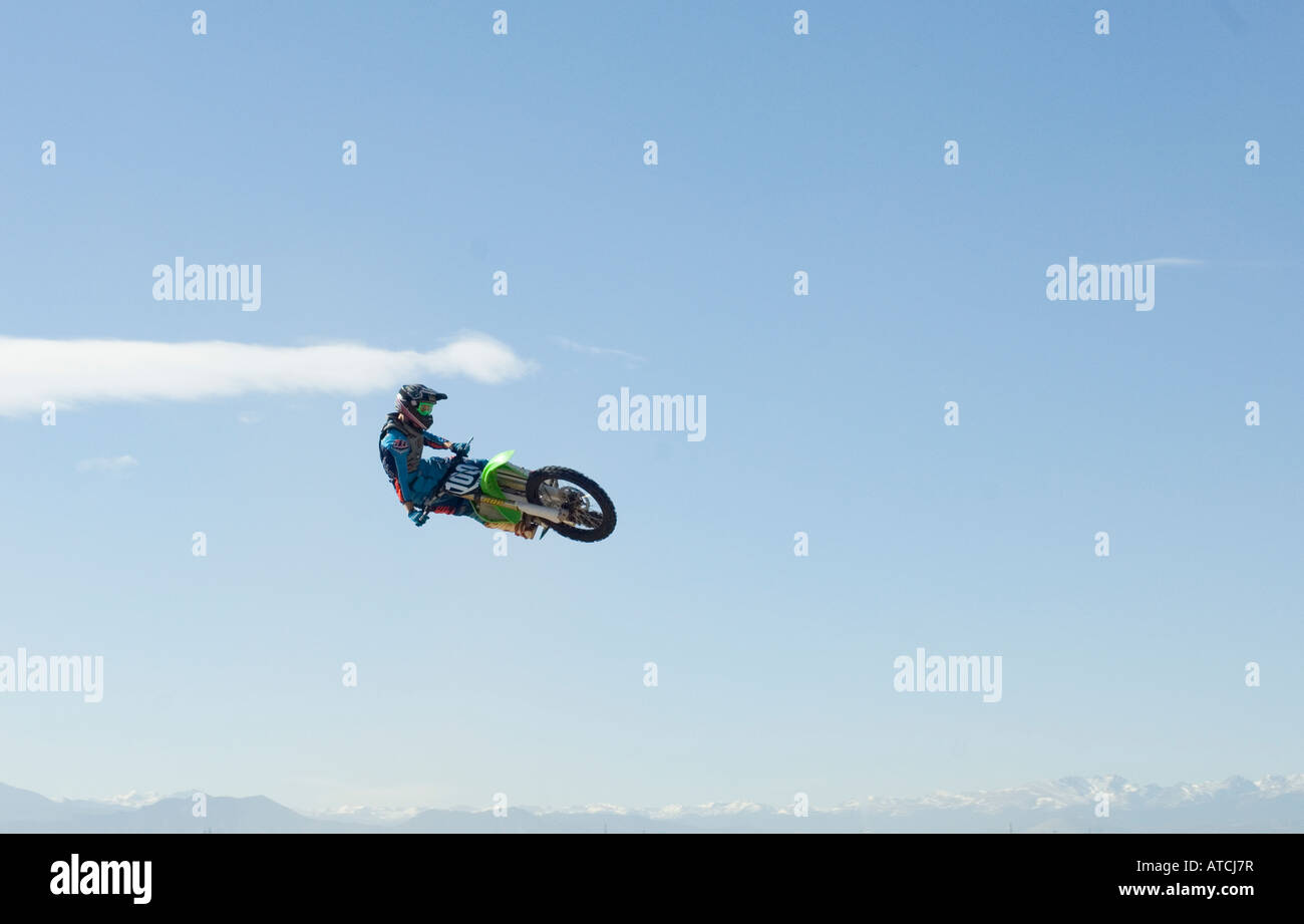 Dirt bike motorcycle rider jumping doing a trick at motocross track ...