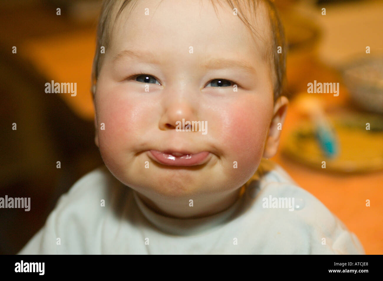 Confident and tough baby boy makes a funny grimace and rejects his ...