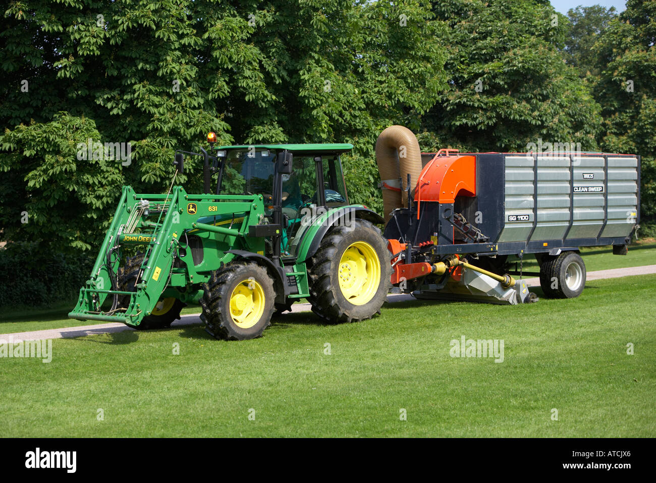 Tractor driven machinery sweeping and vacuuming the lawns of Windsor ...
