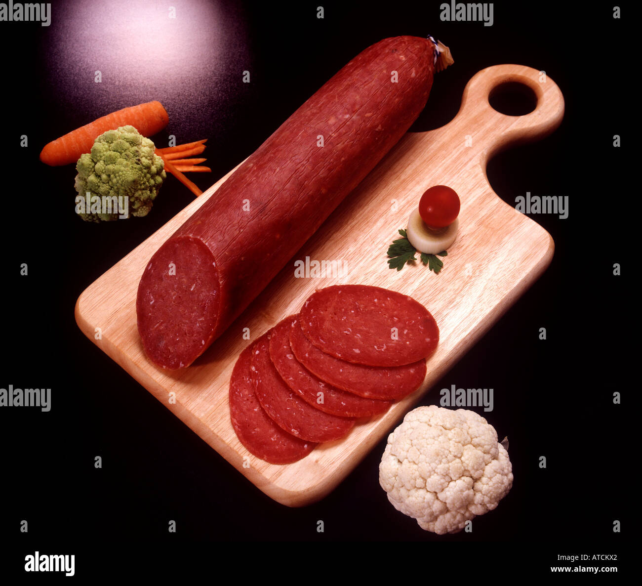 Slices of salamy turkey in plank Stock Photo - Alamy