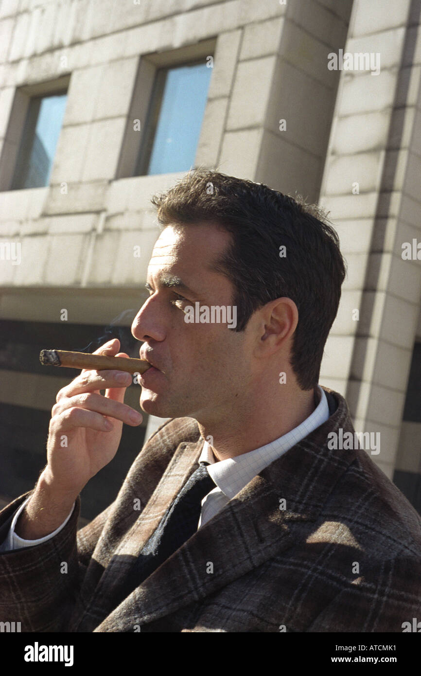 Business man smoking cigar Stock Photo - Alamy