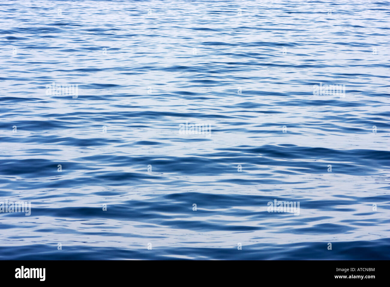 Blue sea with small waves background Stock Photo - Alamy