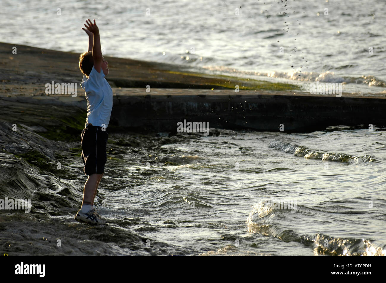 Throwing pebbles sea hi-res stock photography and images - Alamy