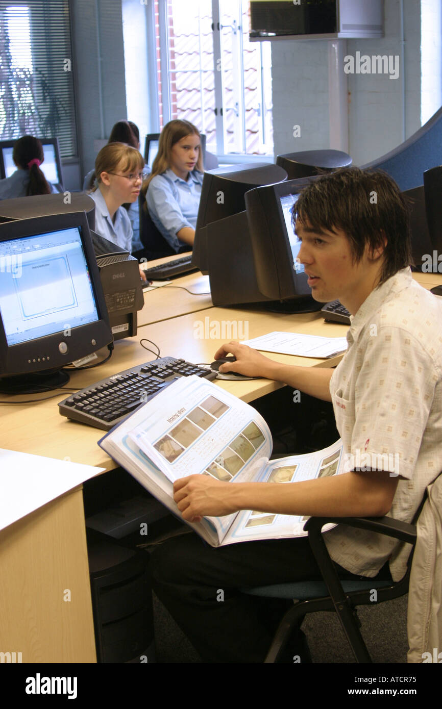 Young male pupil with computer at independent school Stock Photo - Alamy