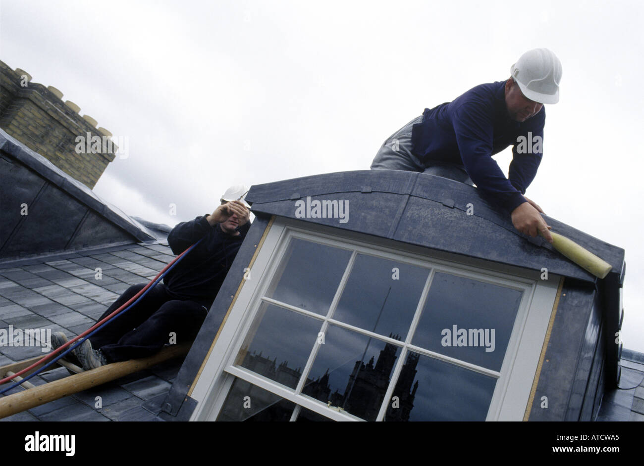 Man working on slate roof hi-res stock photography and images - Alamy