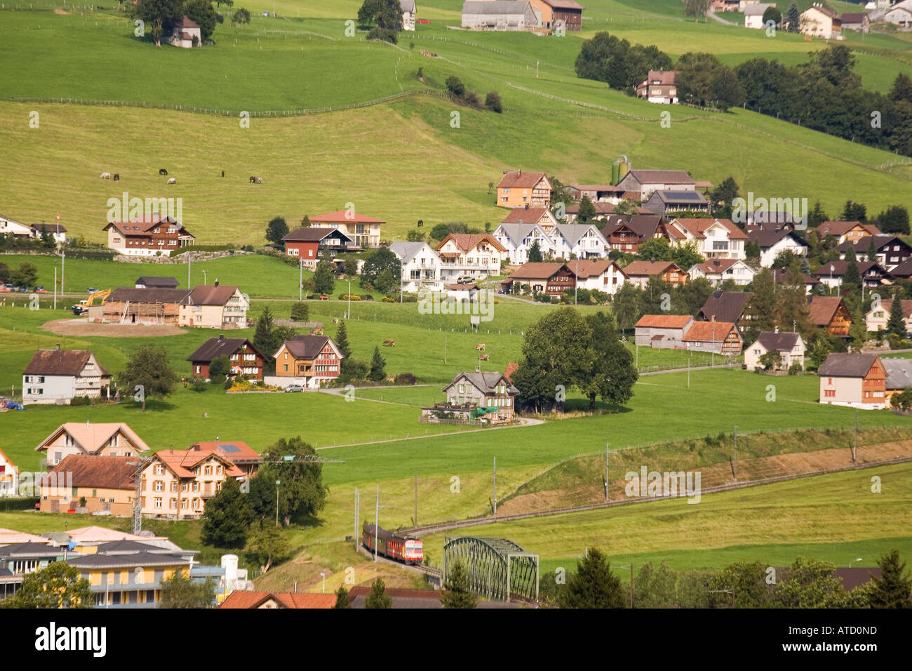 Red Appenzeller Bahnen train approaches the Village of Appenzell ...