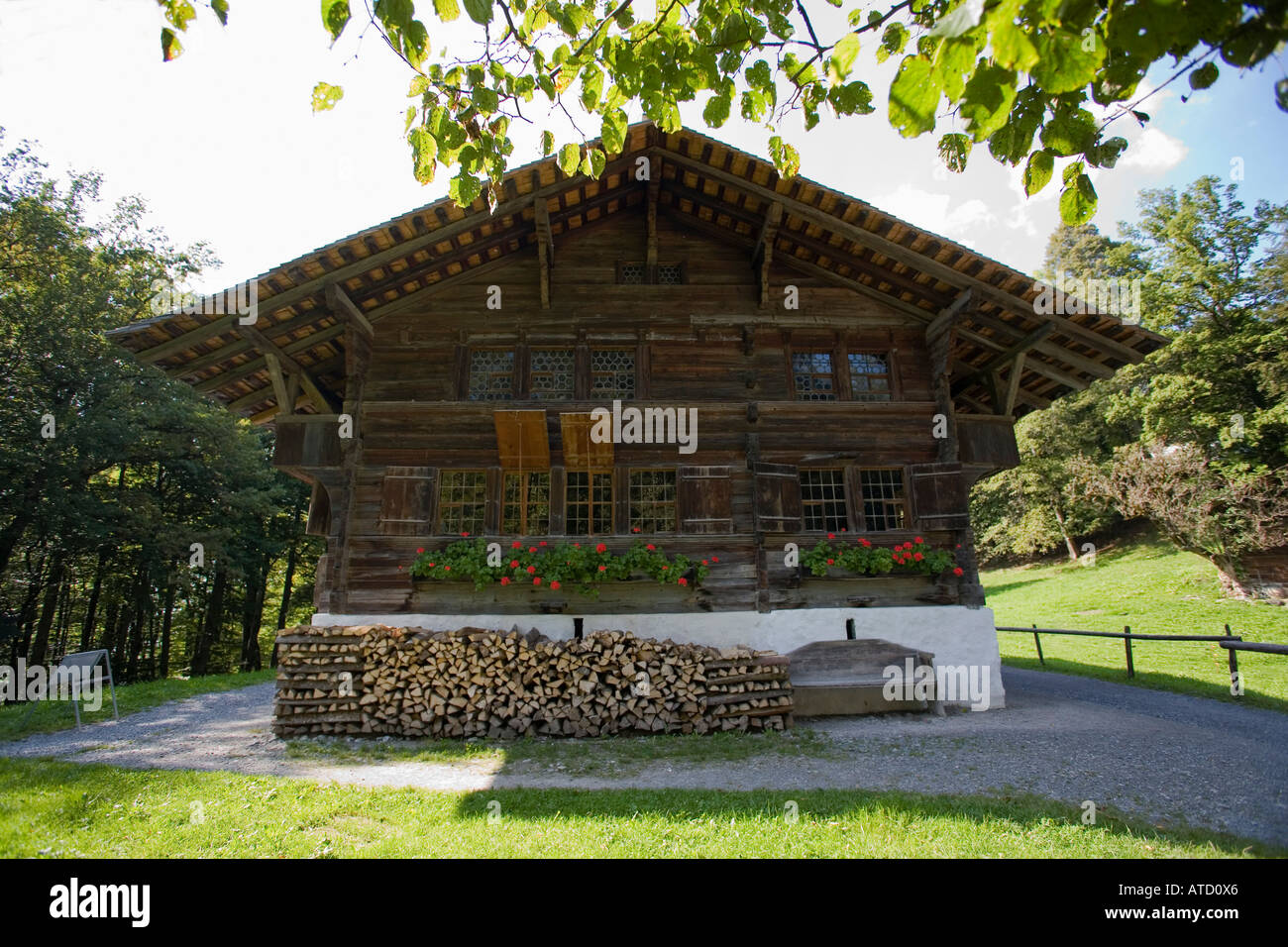 Traditional Swiss Chalet with window boxes and stack of firewood ...