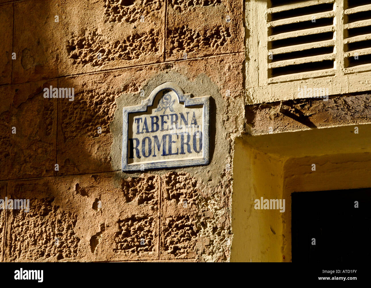 Street sign in Cadiz for a bar, against a wall built from fossilized ...