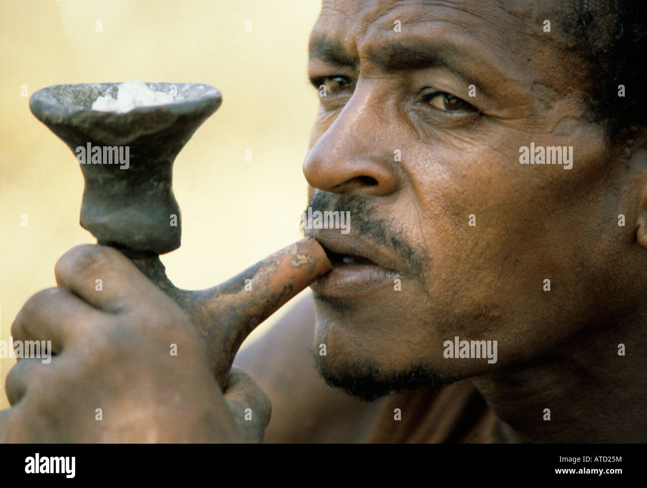 Gofa man smoking a gourd pipe Stock Photo - Alamy