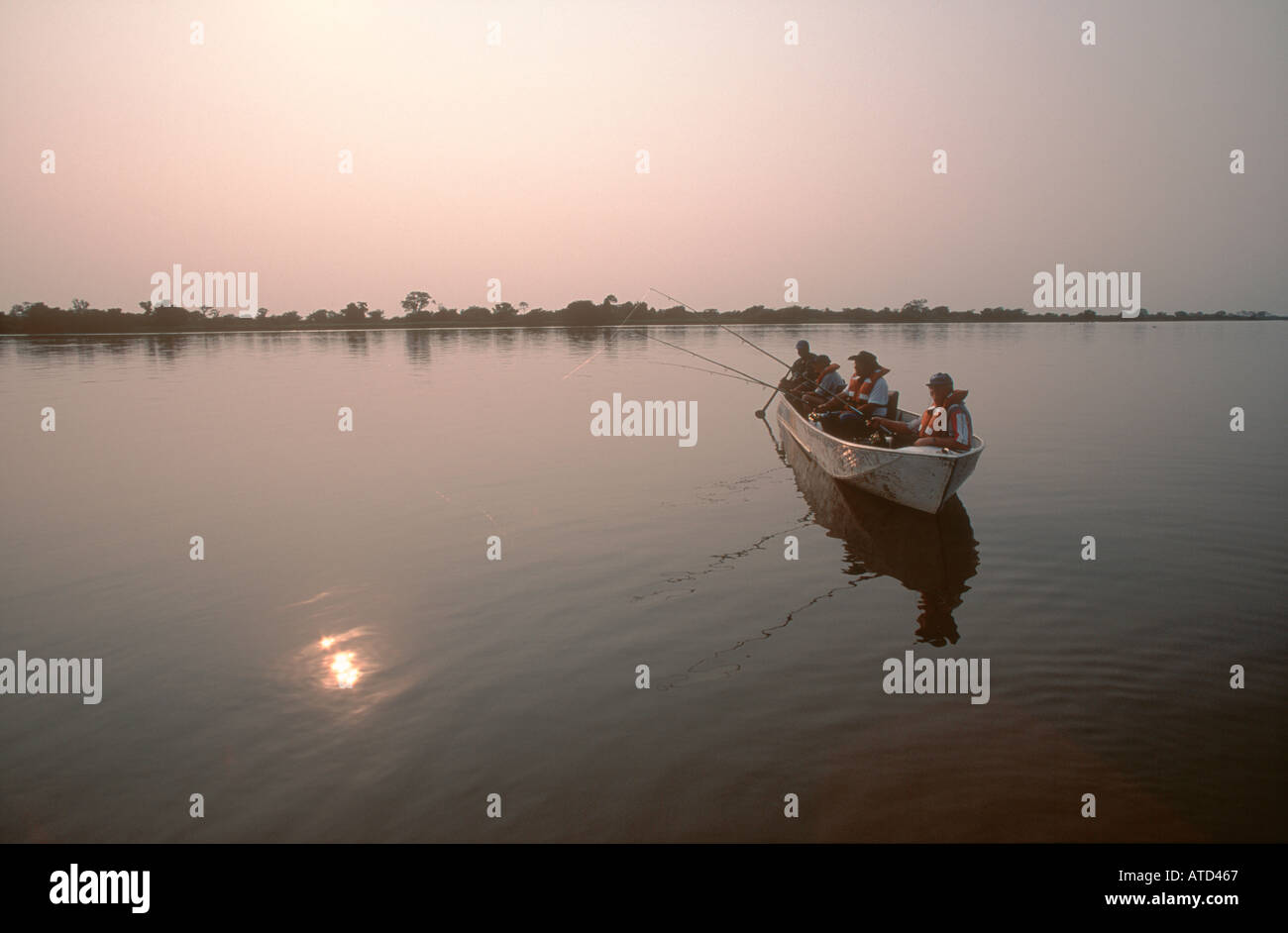Fishermen in a boat in the calm waters of the Miranda river fishing for ...