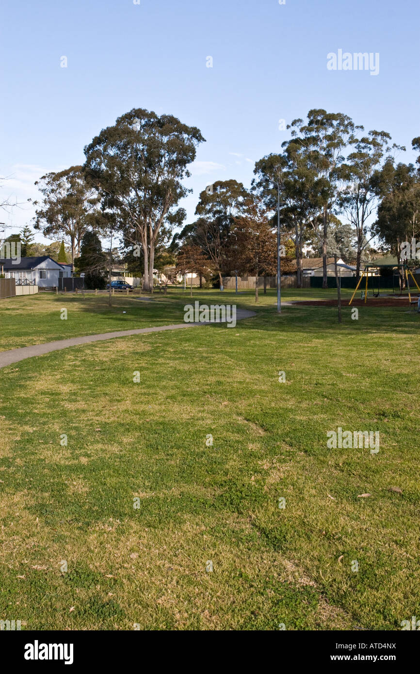 A suburban park with trees and houses in the background Stock Photo - Alamy