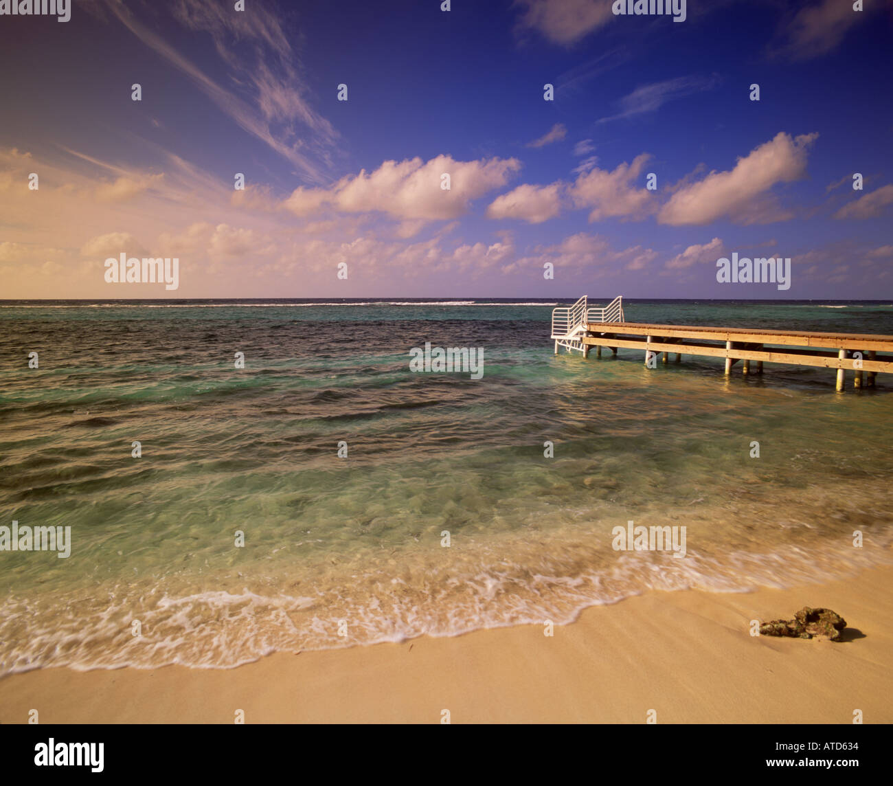 A pier reaches out into the Caribbean at Spotts Beach on Grand Cayman ...