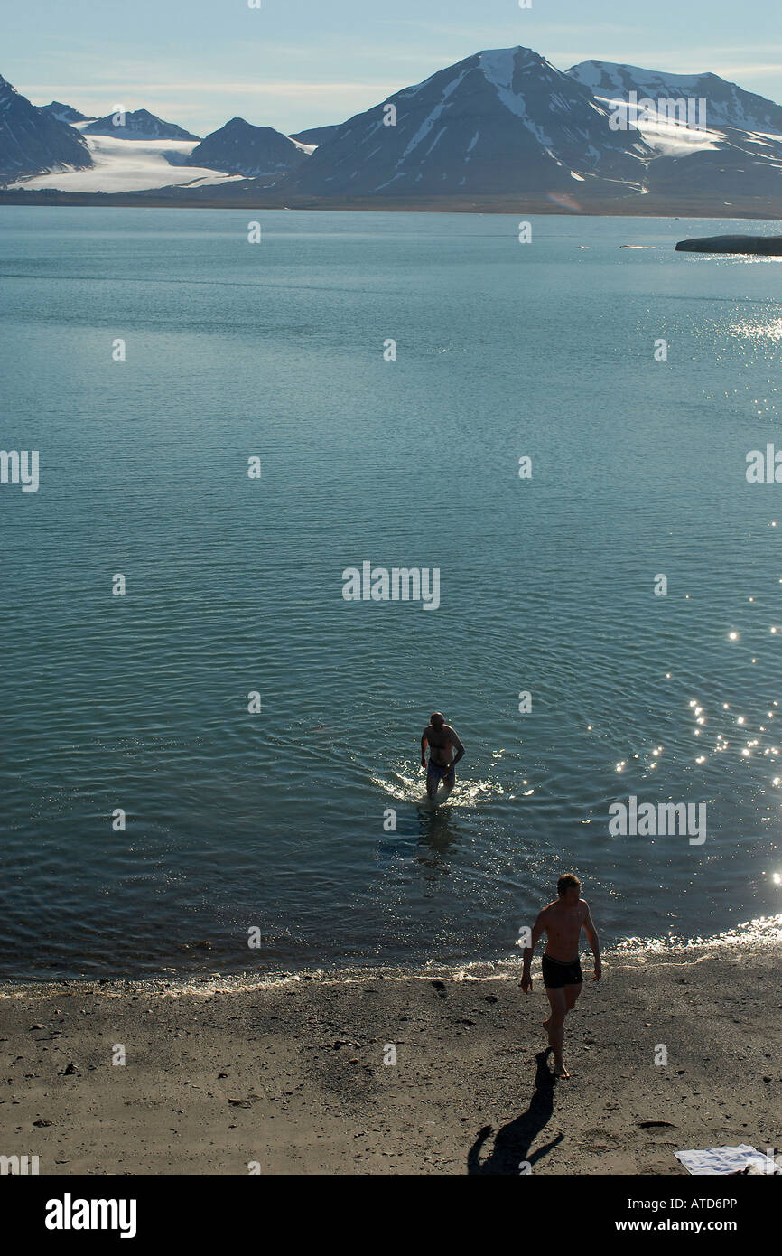 Two men taking a swim in the cold water, Ny London, Norway Stock Photo ...